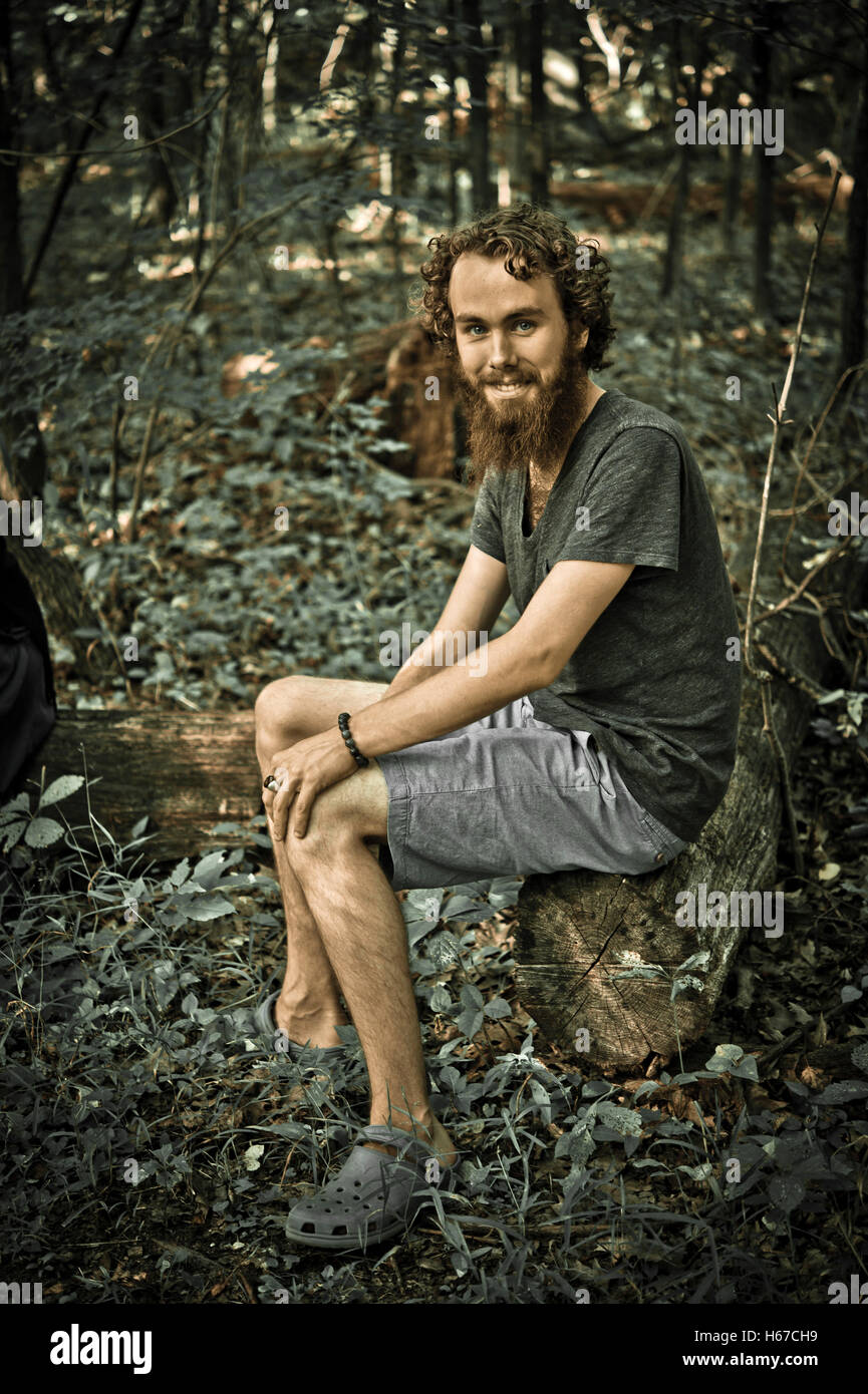 Young man sitting in woods hi-res stock photography and images - Alamy