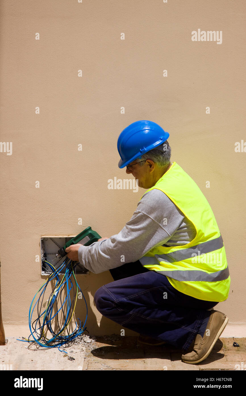 electrician at work in a building site Stock Photo - Alamy