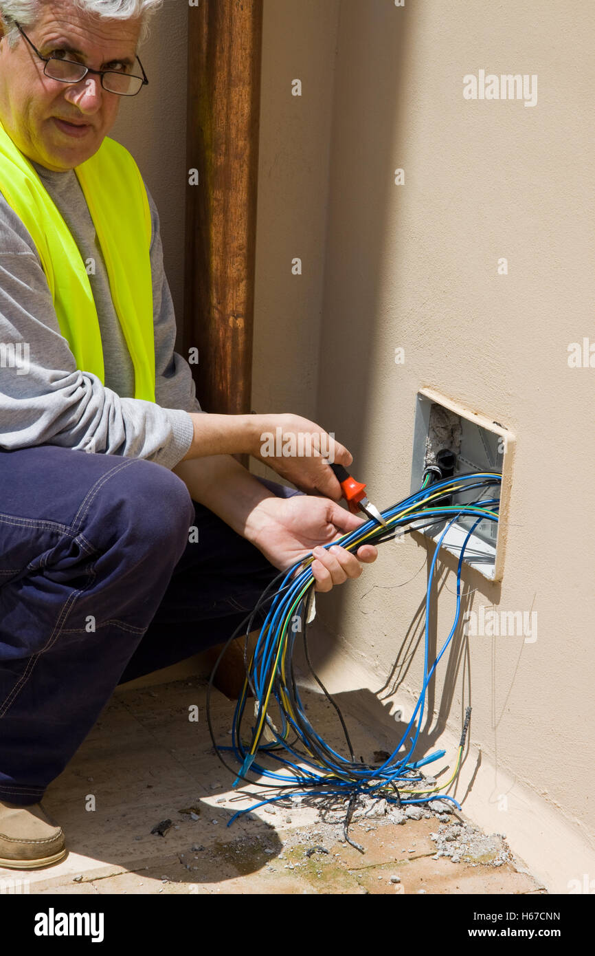 electrician at work in a building site Stock Photo - Alamy