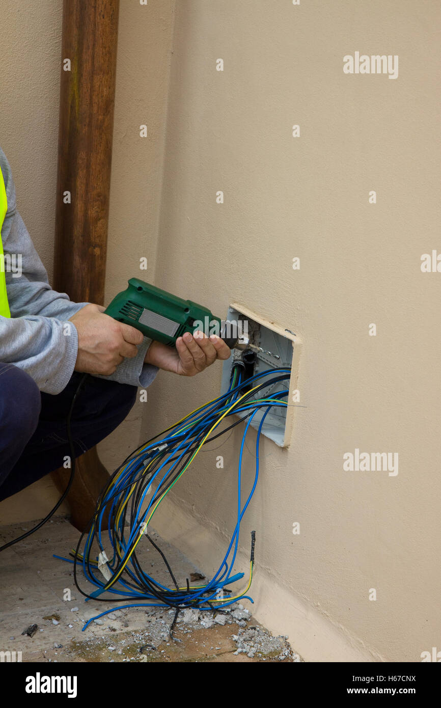 electrician at work in a building site Stock Photo - Alamy
