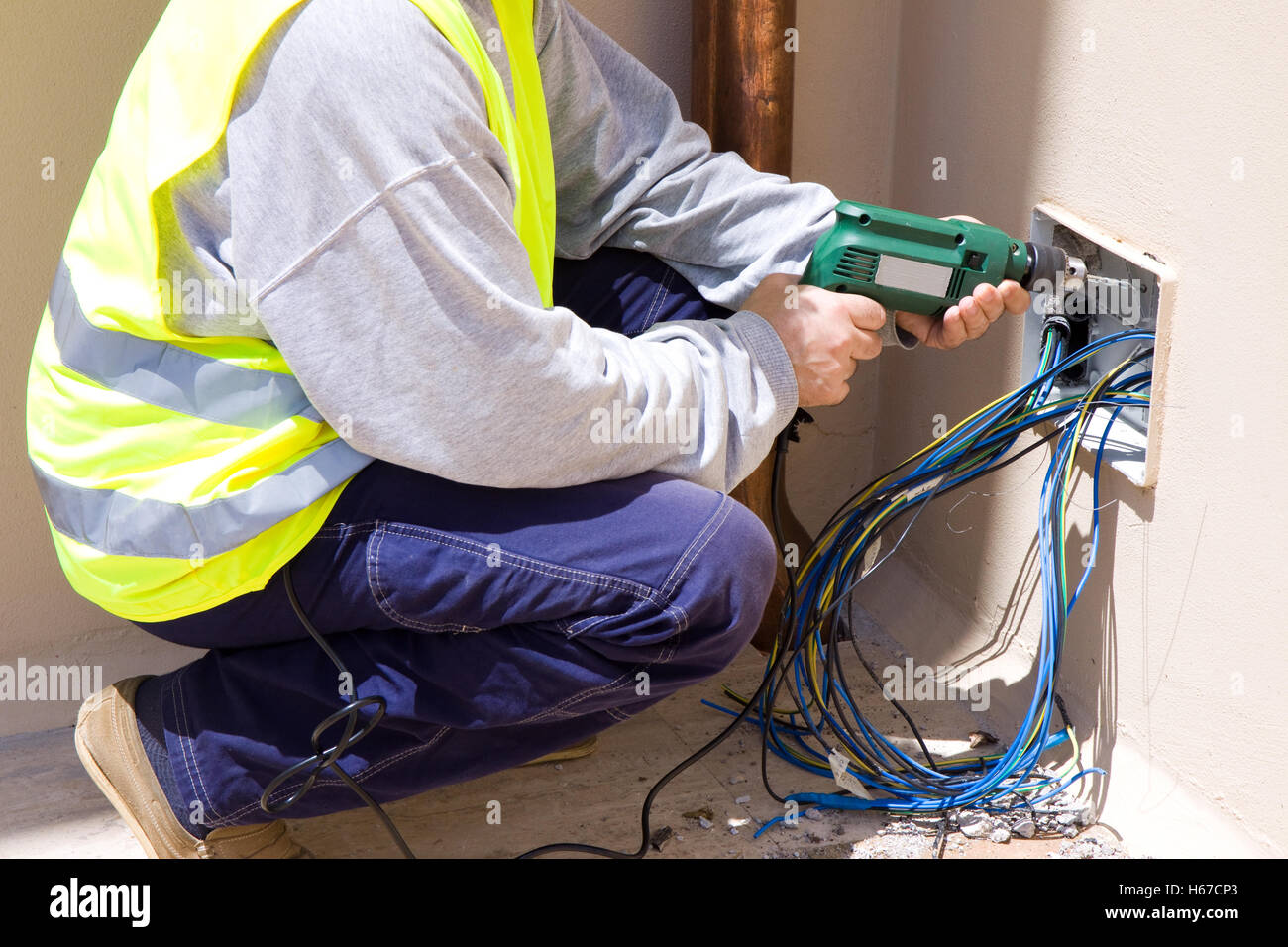 electrician at work in a building site Stock Photo - Alamy