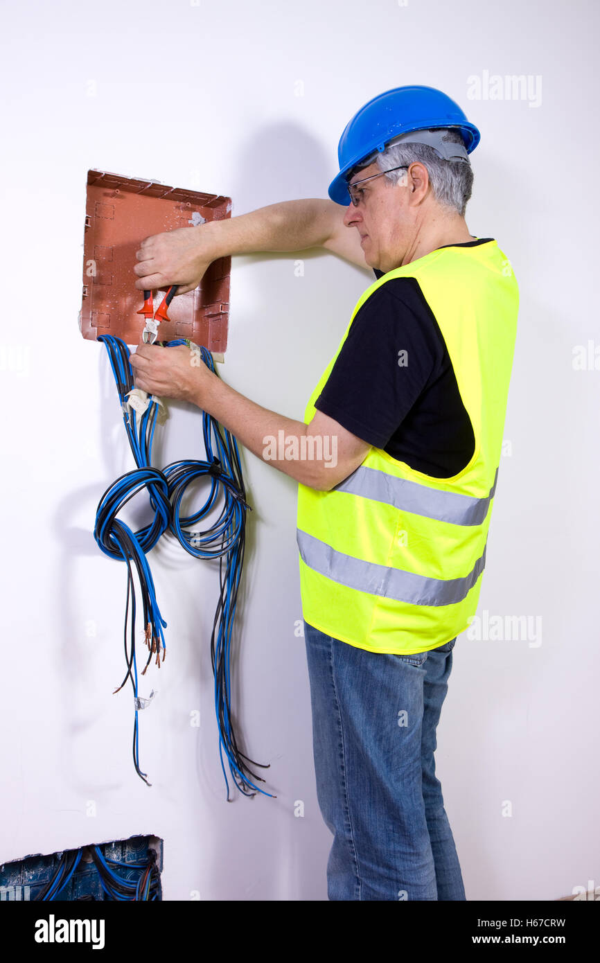 electrician at work in a building site Stock Photo - Alamy