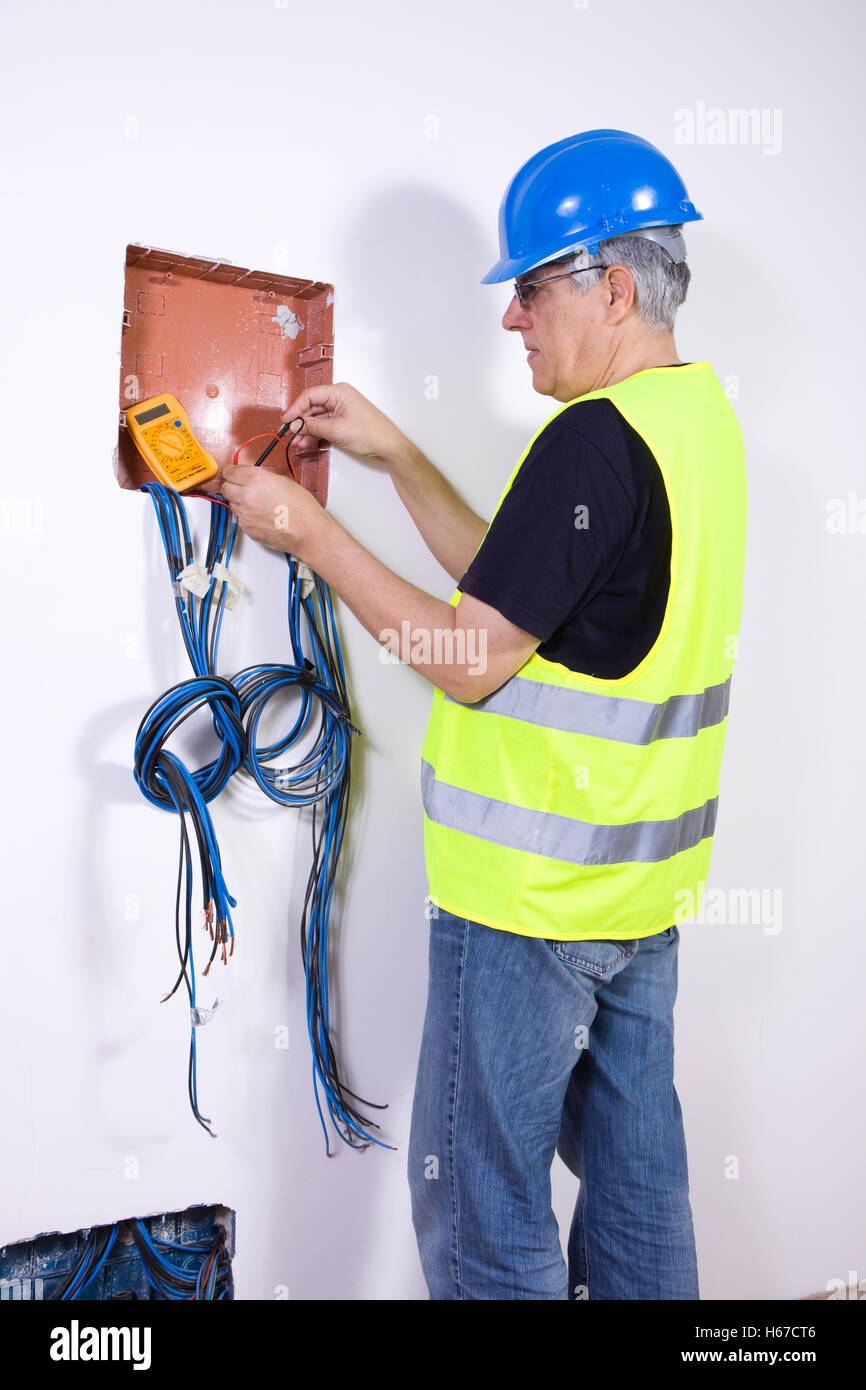 electrician at work in a building site Stock Photo - Alamy