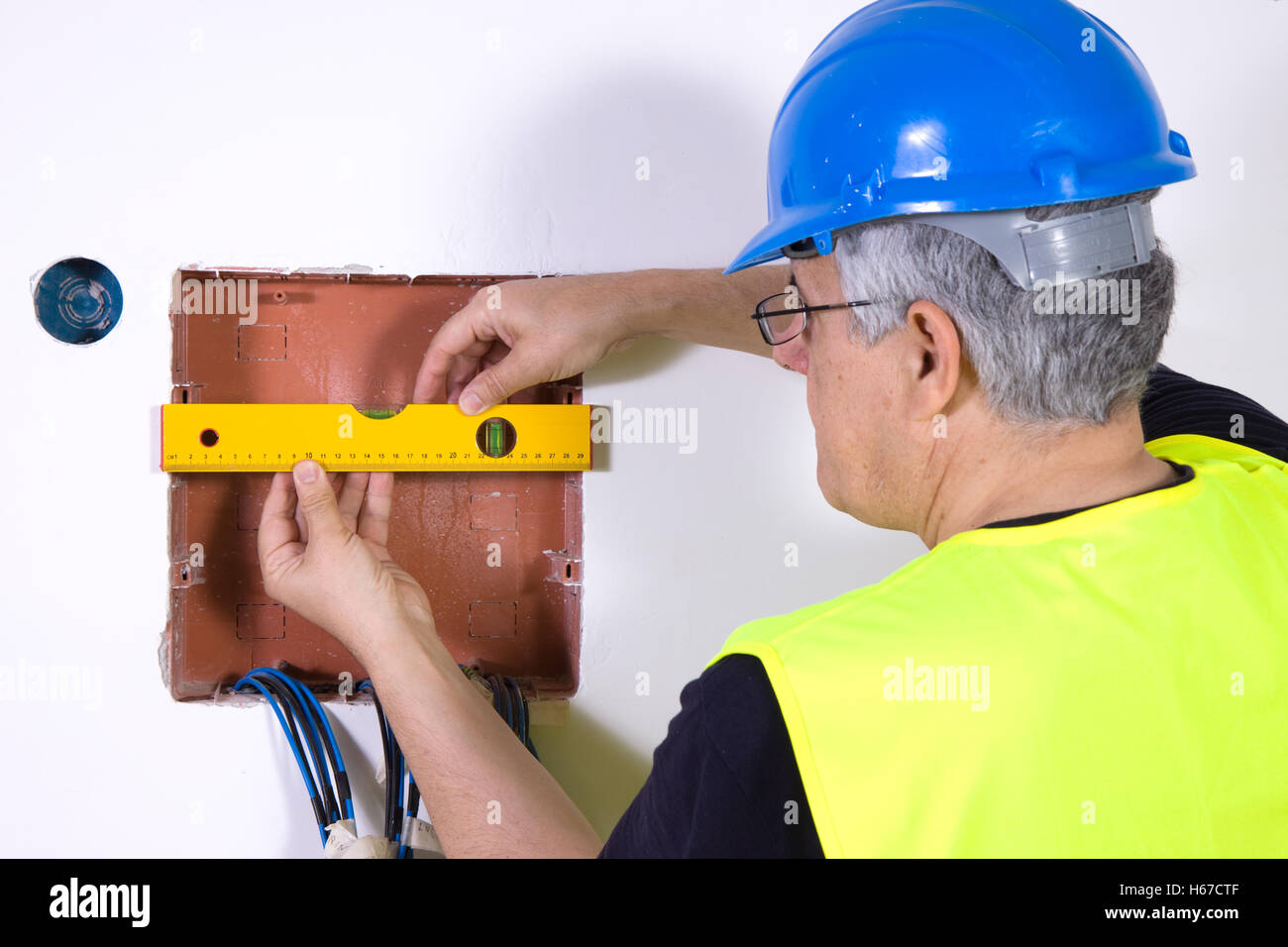 electrician at work in a building site Stock Photo - Alamy