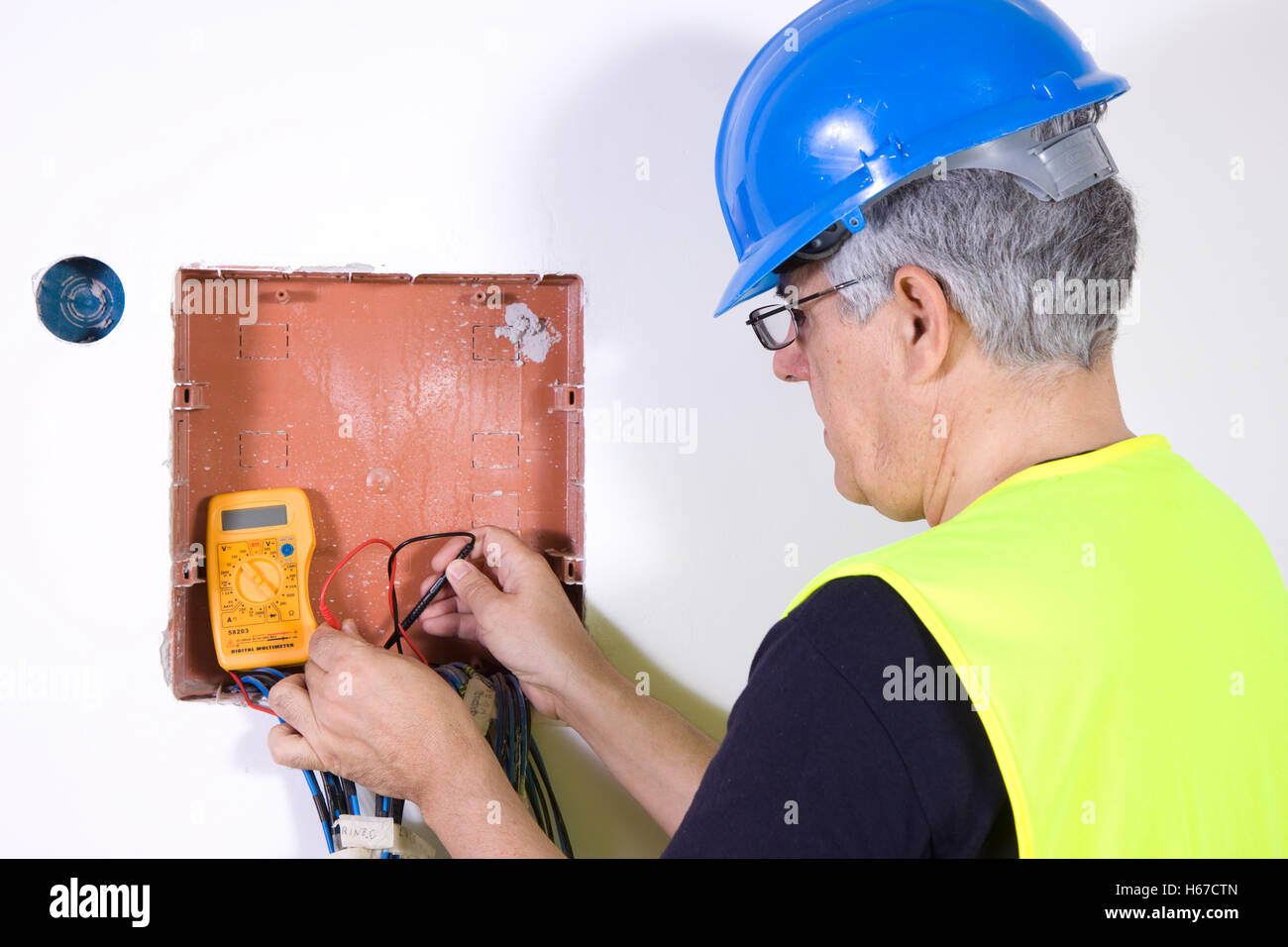 electrician at work in a building site Stock Photo - Alamy
