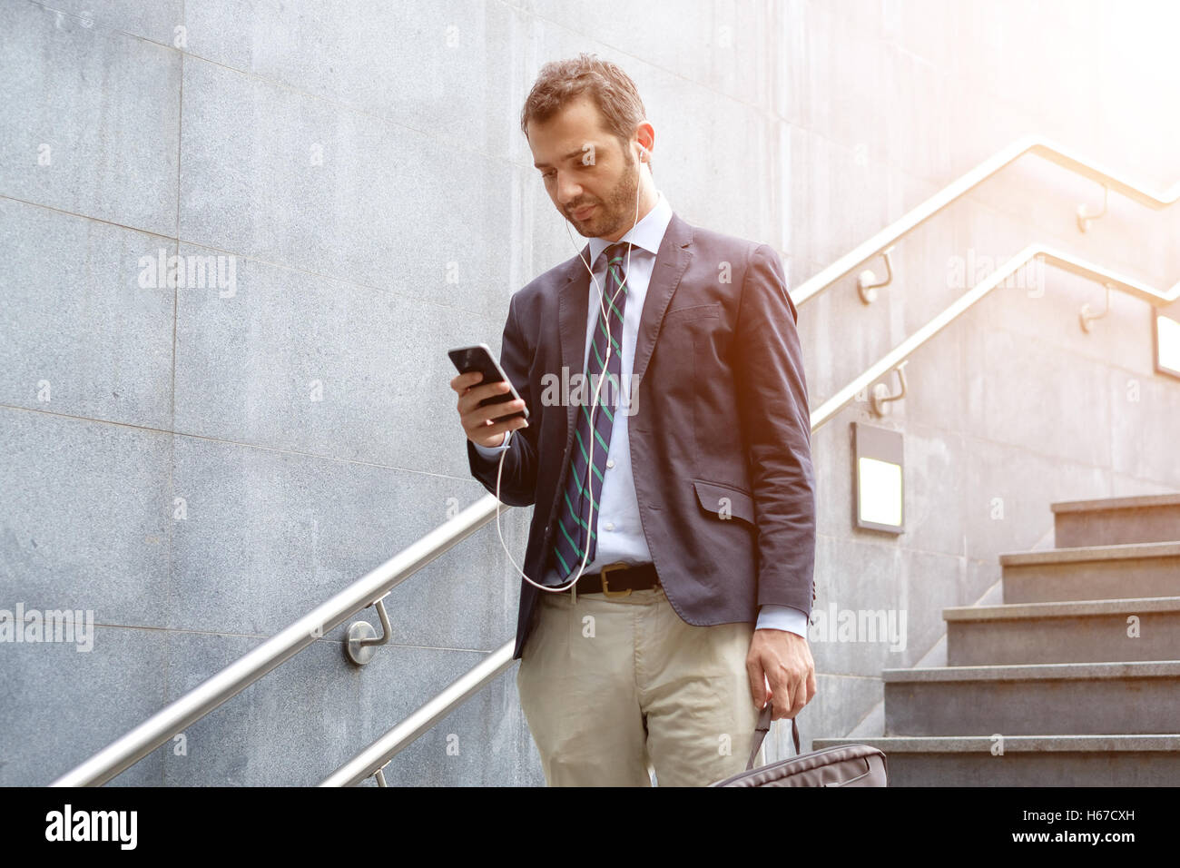 Smart man walking down steps hi-res stock photography and images - Alamy