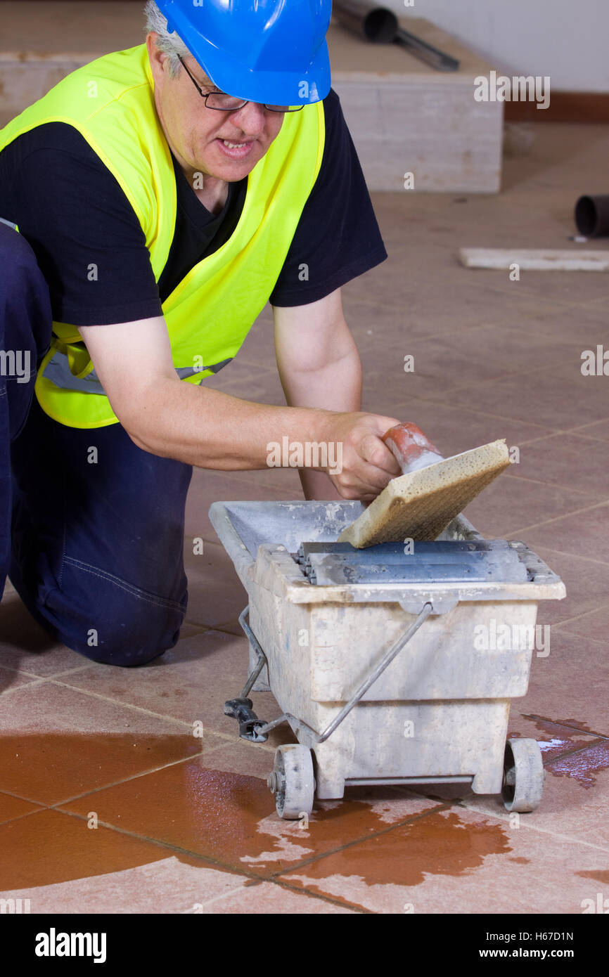 bricklayer cleaning the floor Stock Photo - Alamy