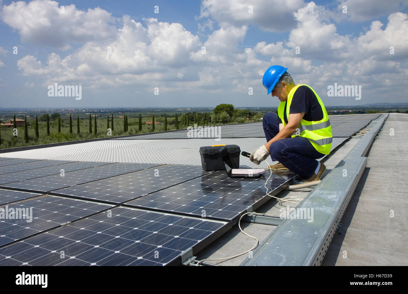 skilled worker fitting a photovoltaic plant on roof Stock Photo - Alamy