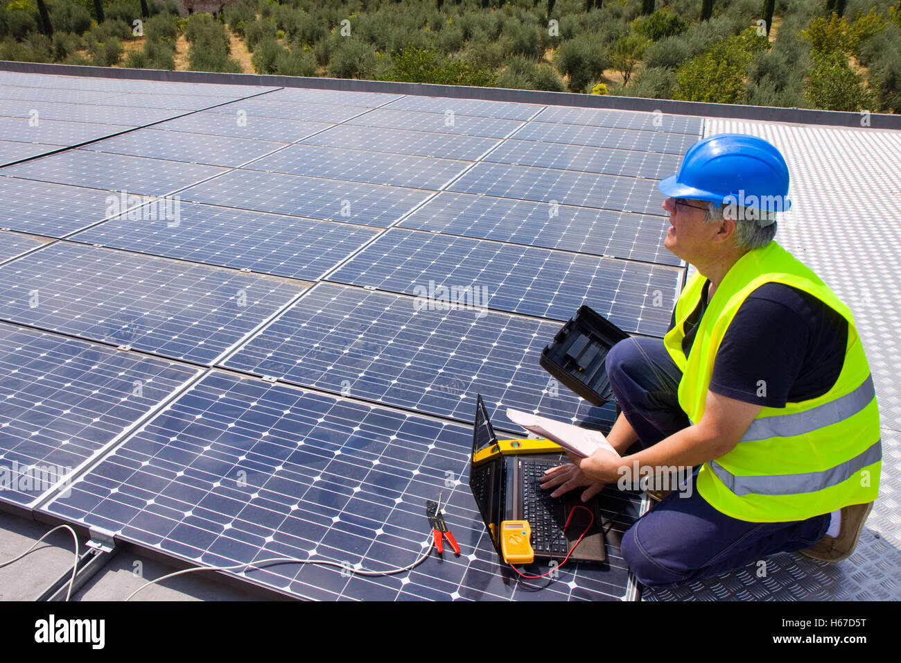 skilled worker fitting a photovoltaic plant on roof Stock Photo - Alamy