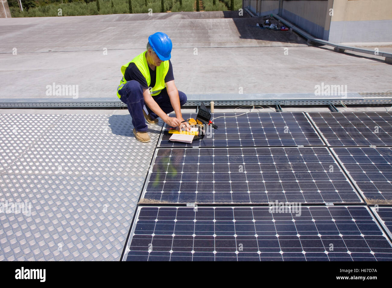 skilled worker fitting a photovoltaic plant on a roof Stock Photo - Alamy