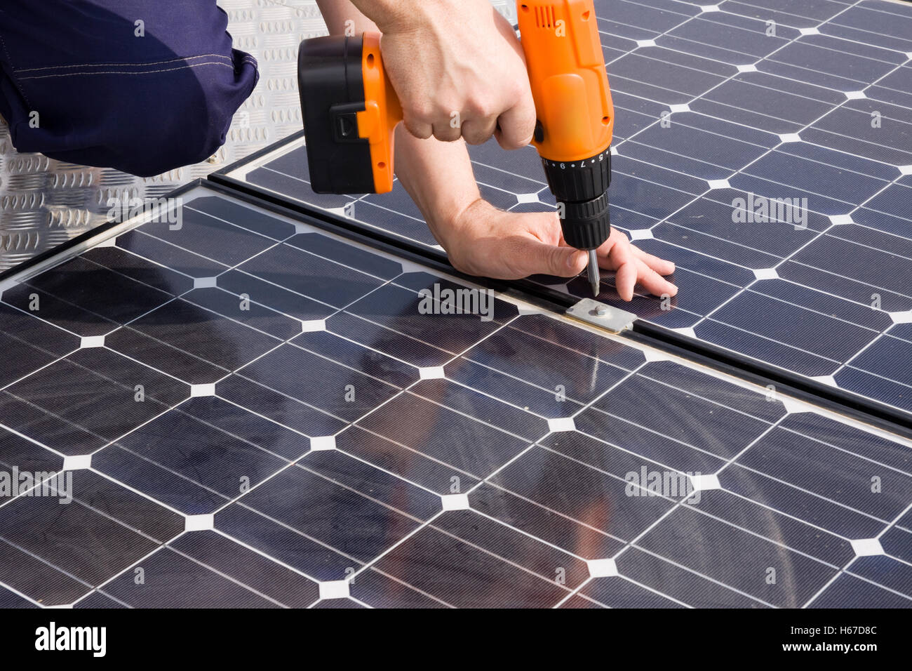 skilled worker fitting a photovoltaic plant on a roof Stock Photo - Alamy