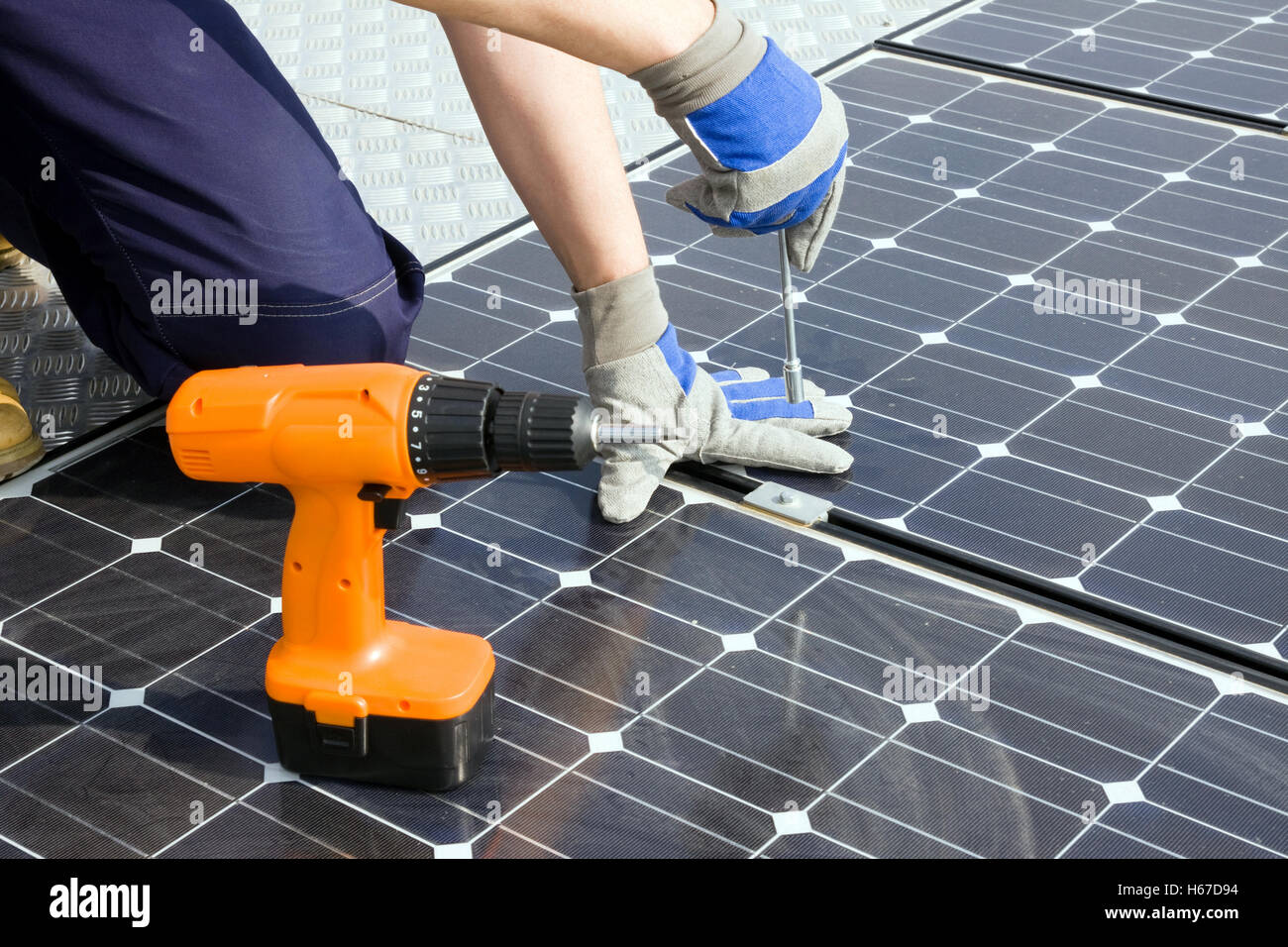 skilled worker fitting a photovoltaic plant on a roof Stock Photo - Alamy