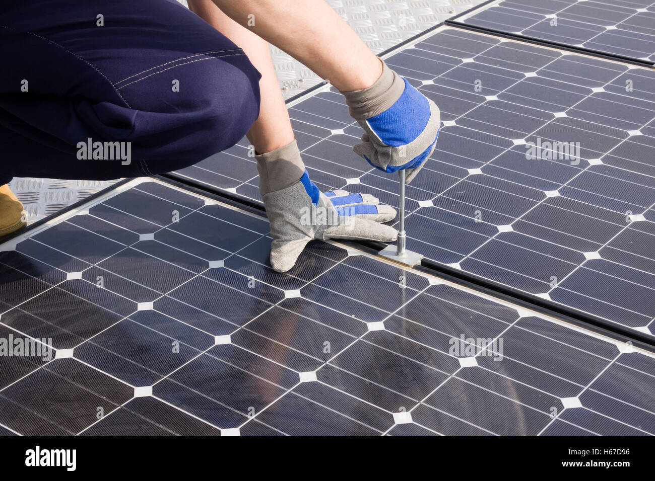 skilled worker fitting a photovoltaic plant on a roof Stock Photo - Alamy