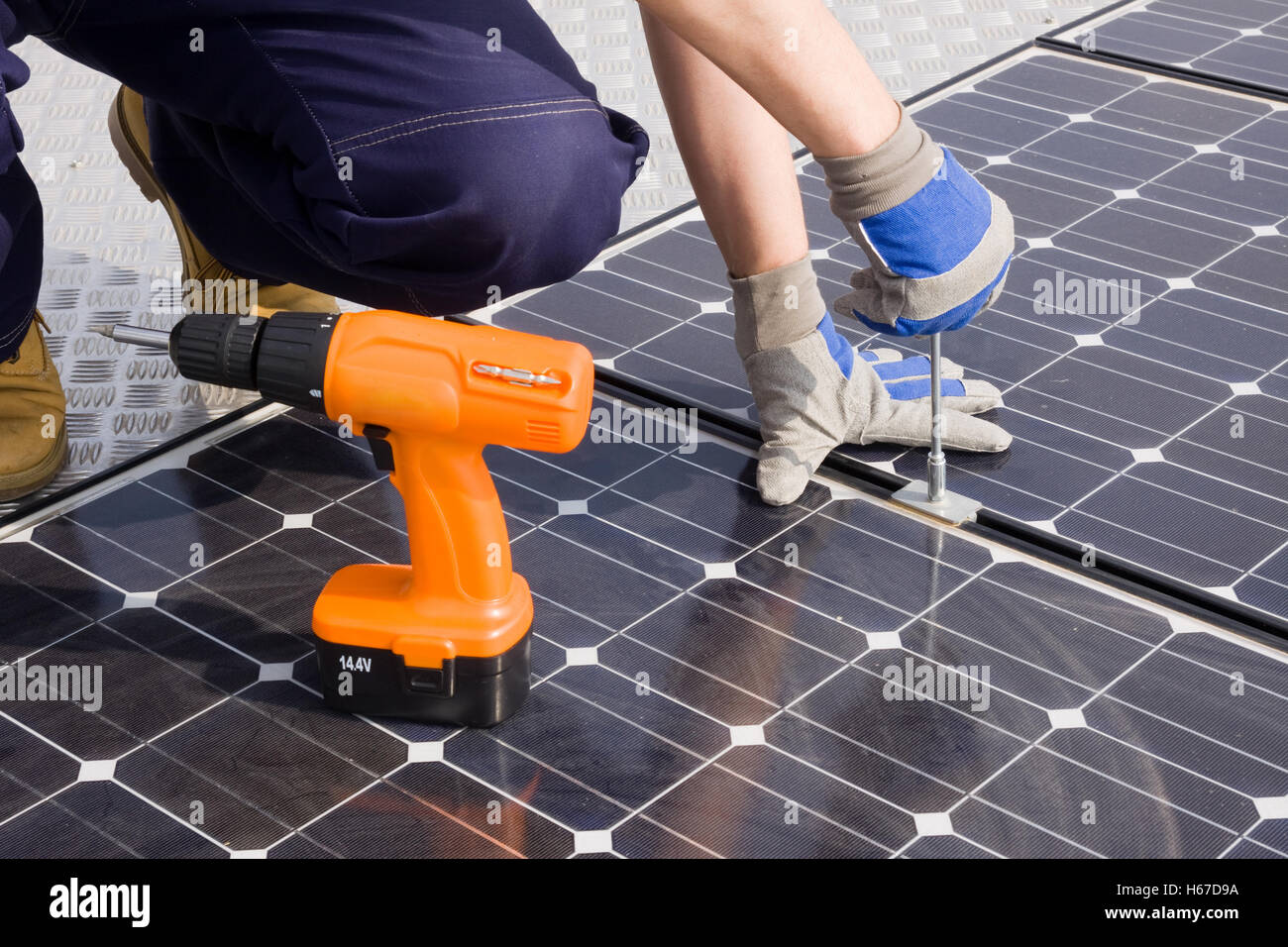 skilled worker fitting a photovoltaic plant on a roof Stock Photo - Alamy