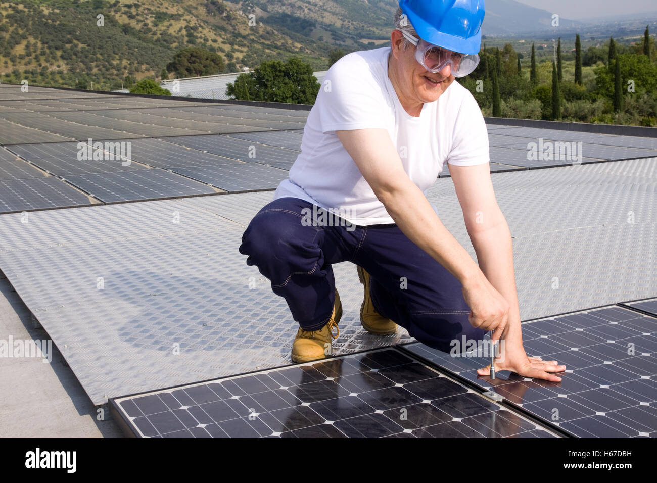 skilled woker fitting a photovoltaic plant on a roof Stock Photo - Alamy