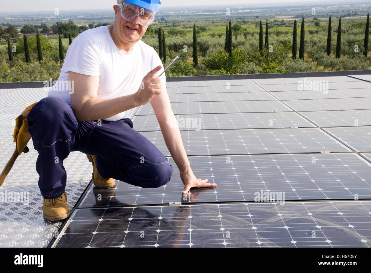 skilled woker fitting a photovoltaic plant on a roof Stock Photo - Alamy