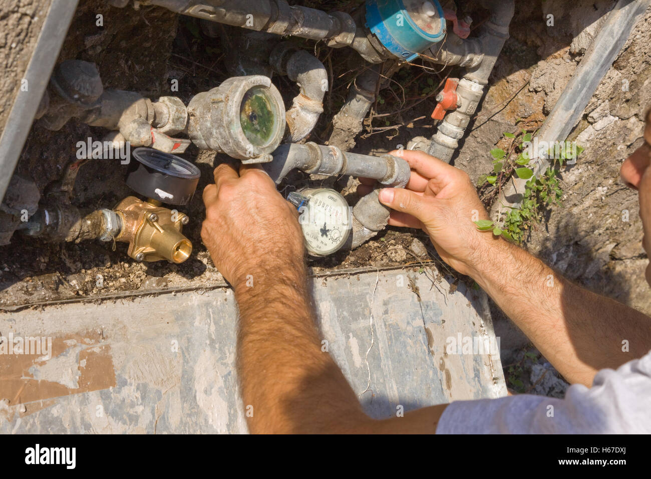 plumber fitting some pipes in a building site Stock Photo - Alamy