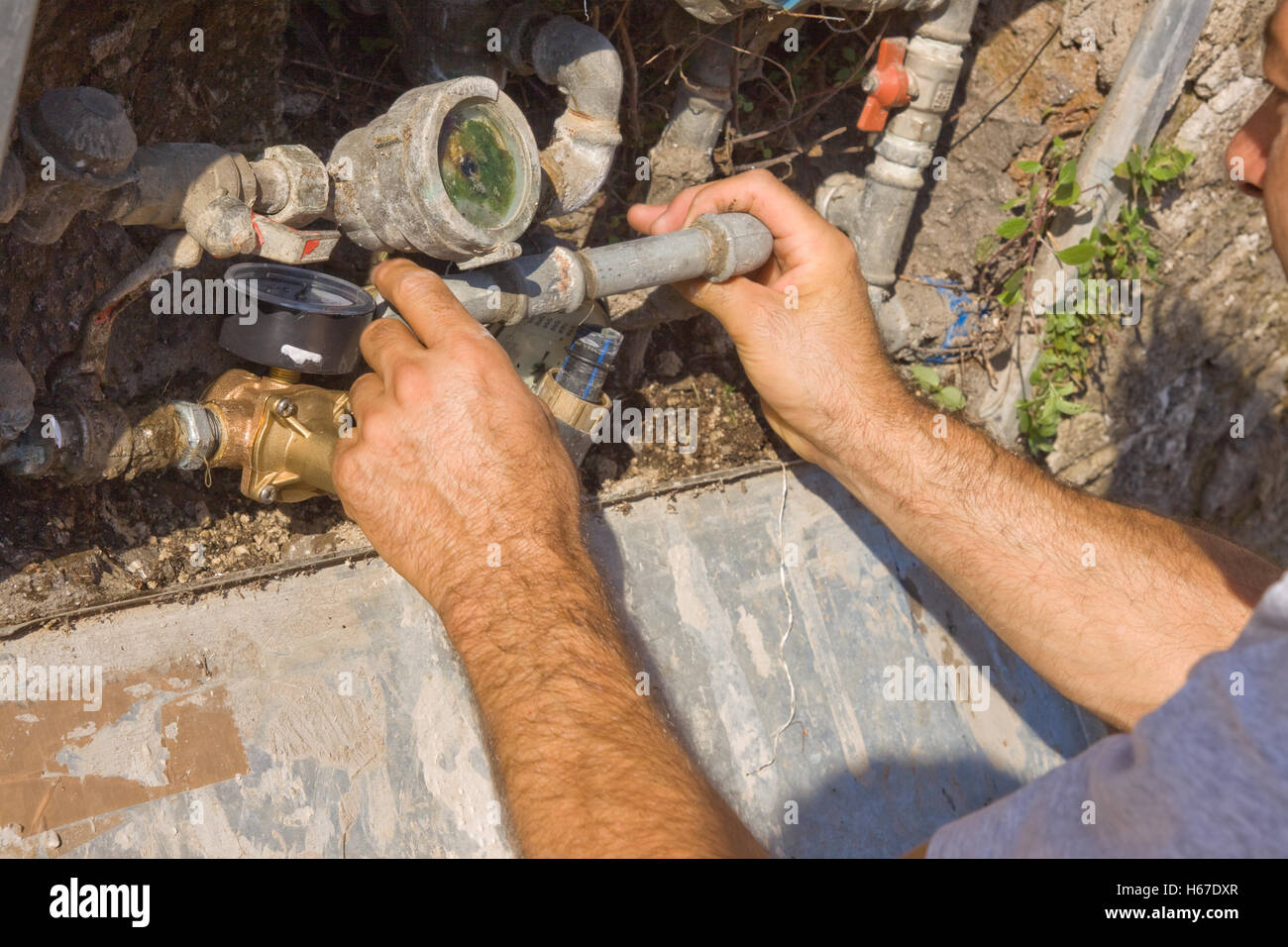 plumber fitting some pipes in a building site Stock Photo - Alamy