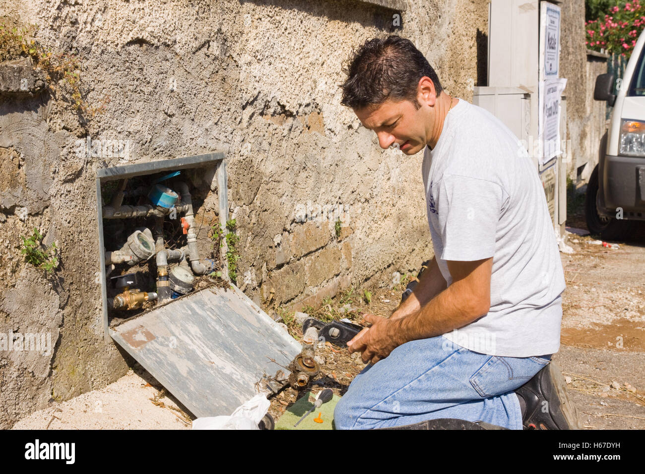 plumber fitting some pipes in a building site Stock Photo - Alamy