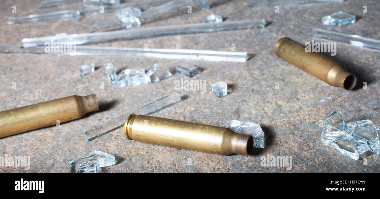 Broken glass with empty rifle cartridges on concrete Stock Photo - Alamy