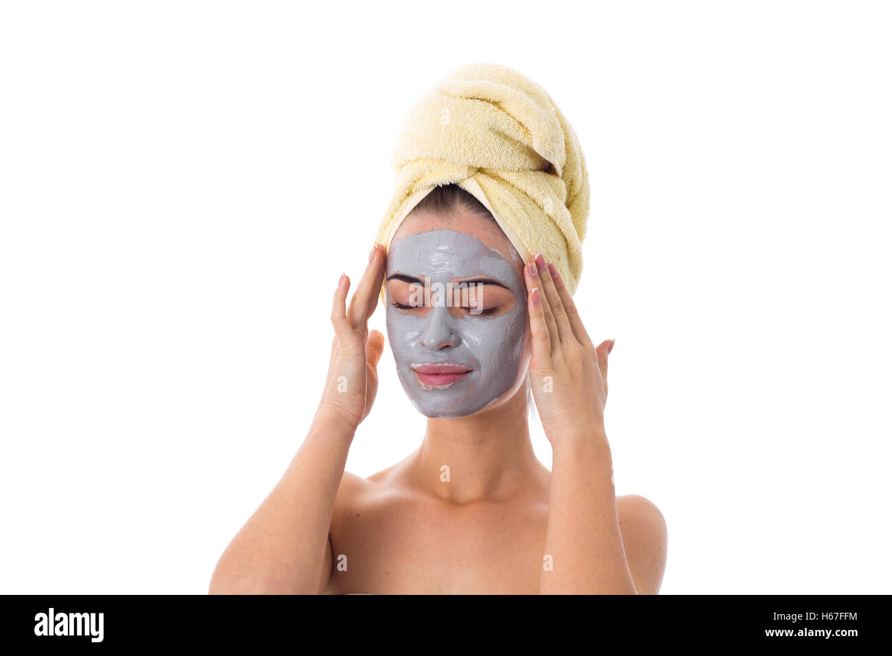 Woman with towel on her head and cosmetic mask on her face Stock Photo ...