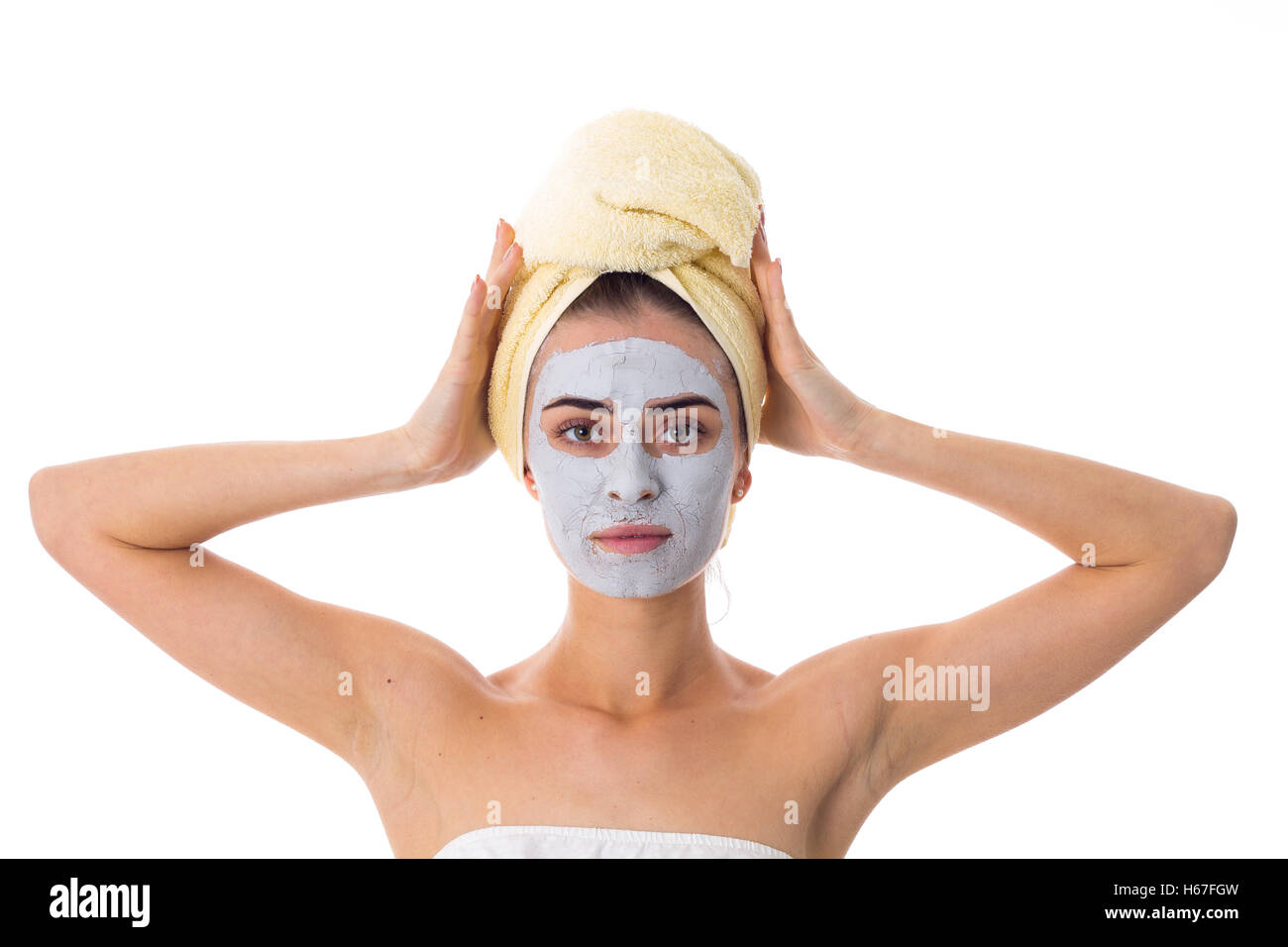 Woman with towel on her head and cosmetic mask on her face Stock Photo ...