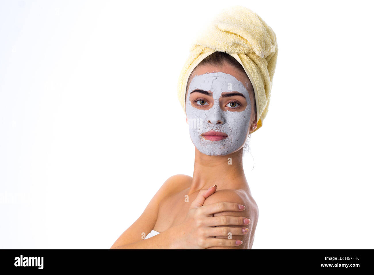 Woman with towel on her head and cosmetic mask on her face Stock Photo ...