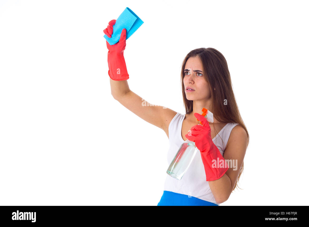 Woman using duster and detergent Stock Photo - Alamy