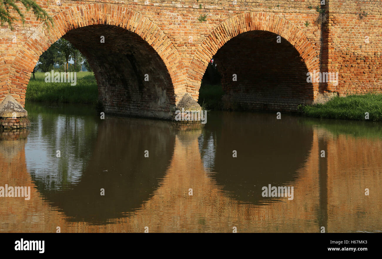 medieval bridge made of red brick on the river in Europe Stock Photo ...