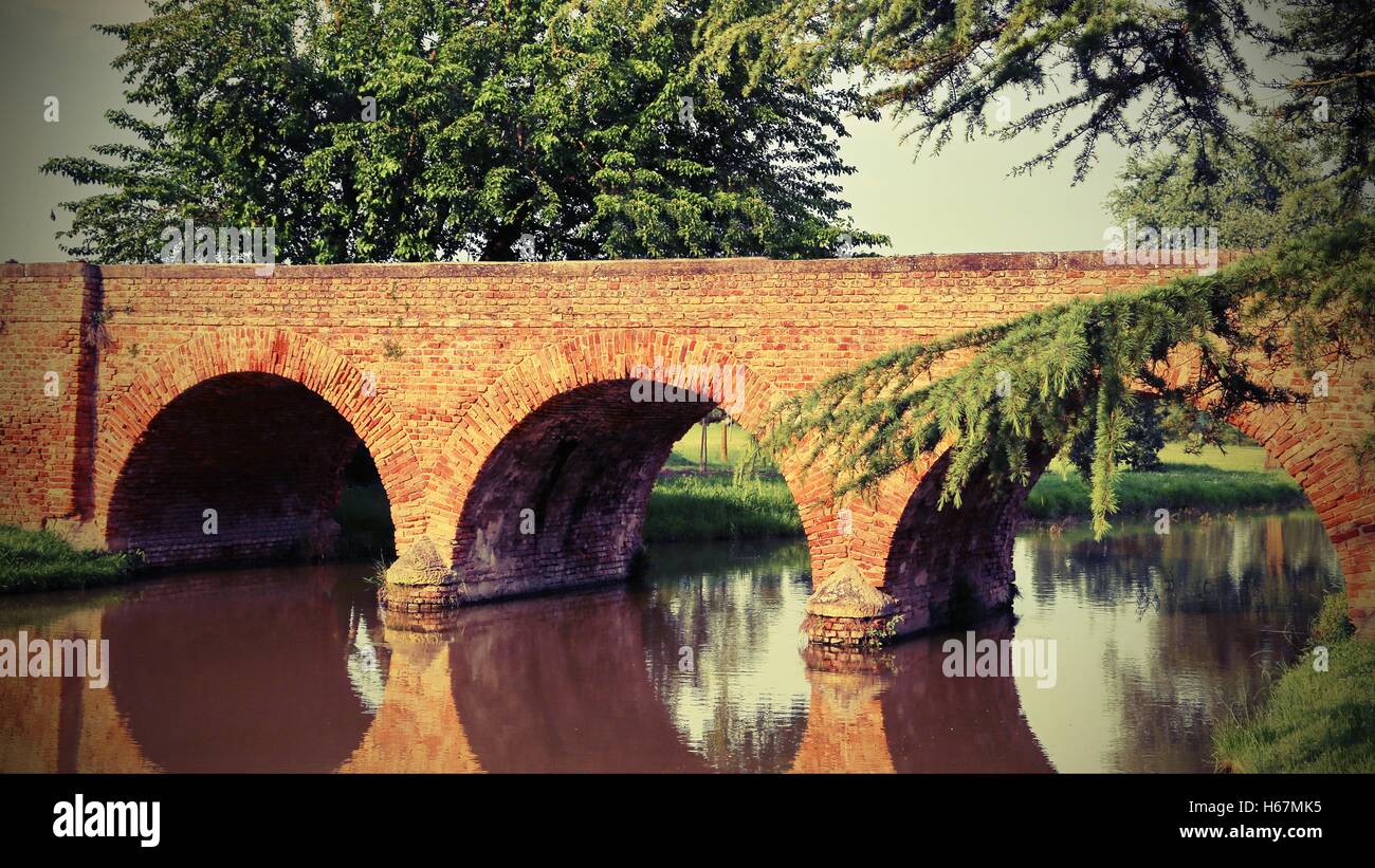 medieval bridge made of red brick with arches Stock Photo - Alamy