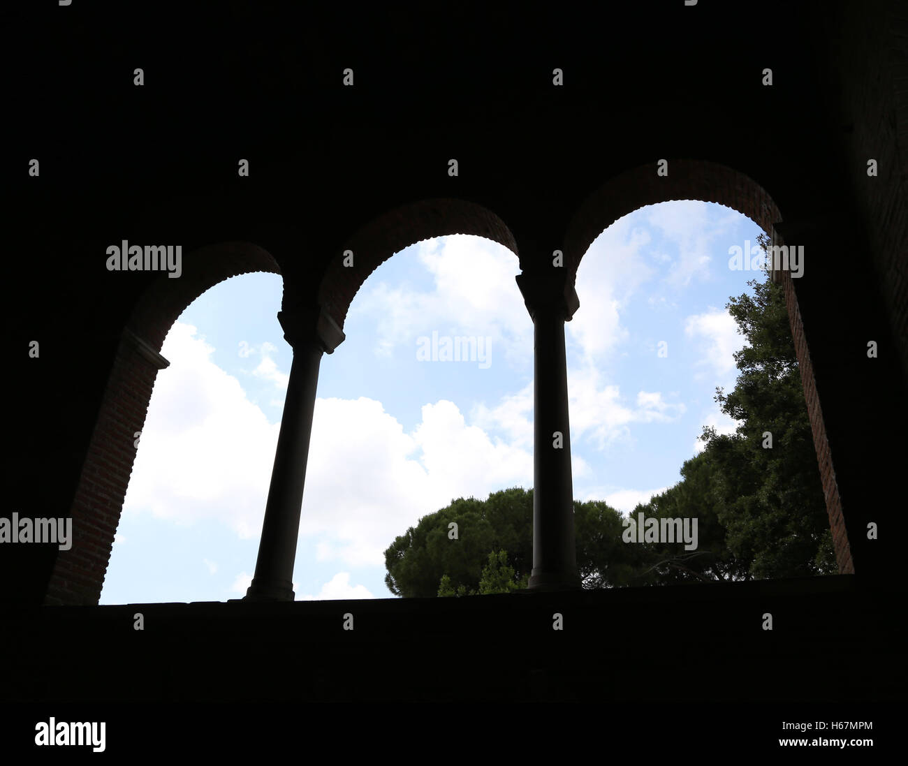 arched windows and small columns on the facade of an ancient medieval ...