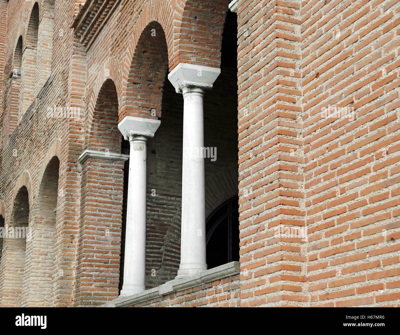 arched windows and columns on the facade of an ancient medieval church ...