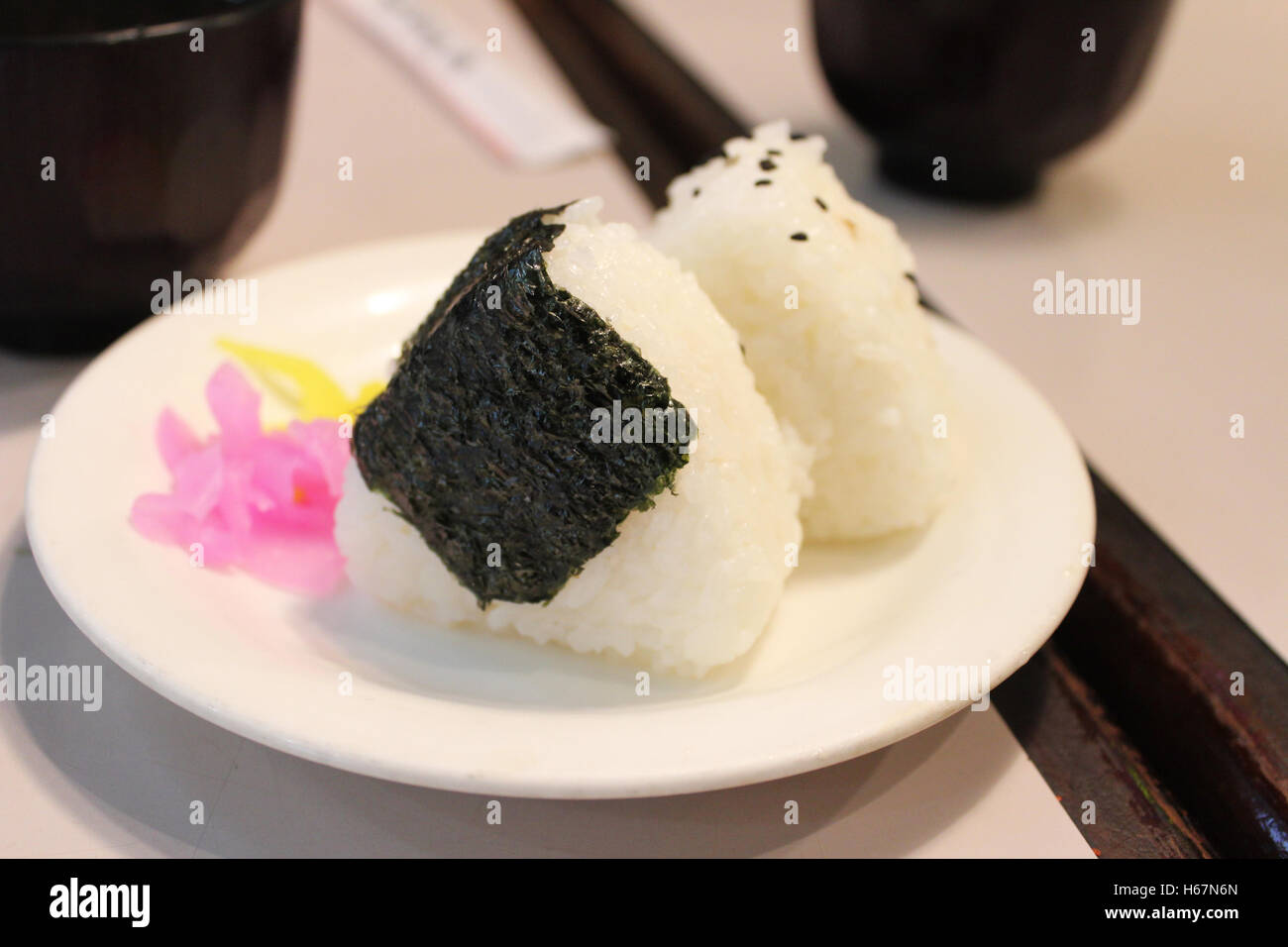 Rice ball with seaweed and colourful pickles at Japanese restaurant in ...