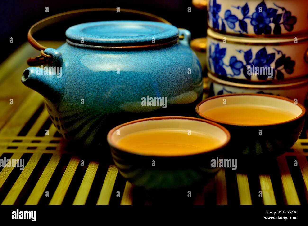 Chinese tea set with blue teapot, two teacups with Oolong tea and a ...