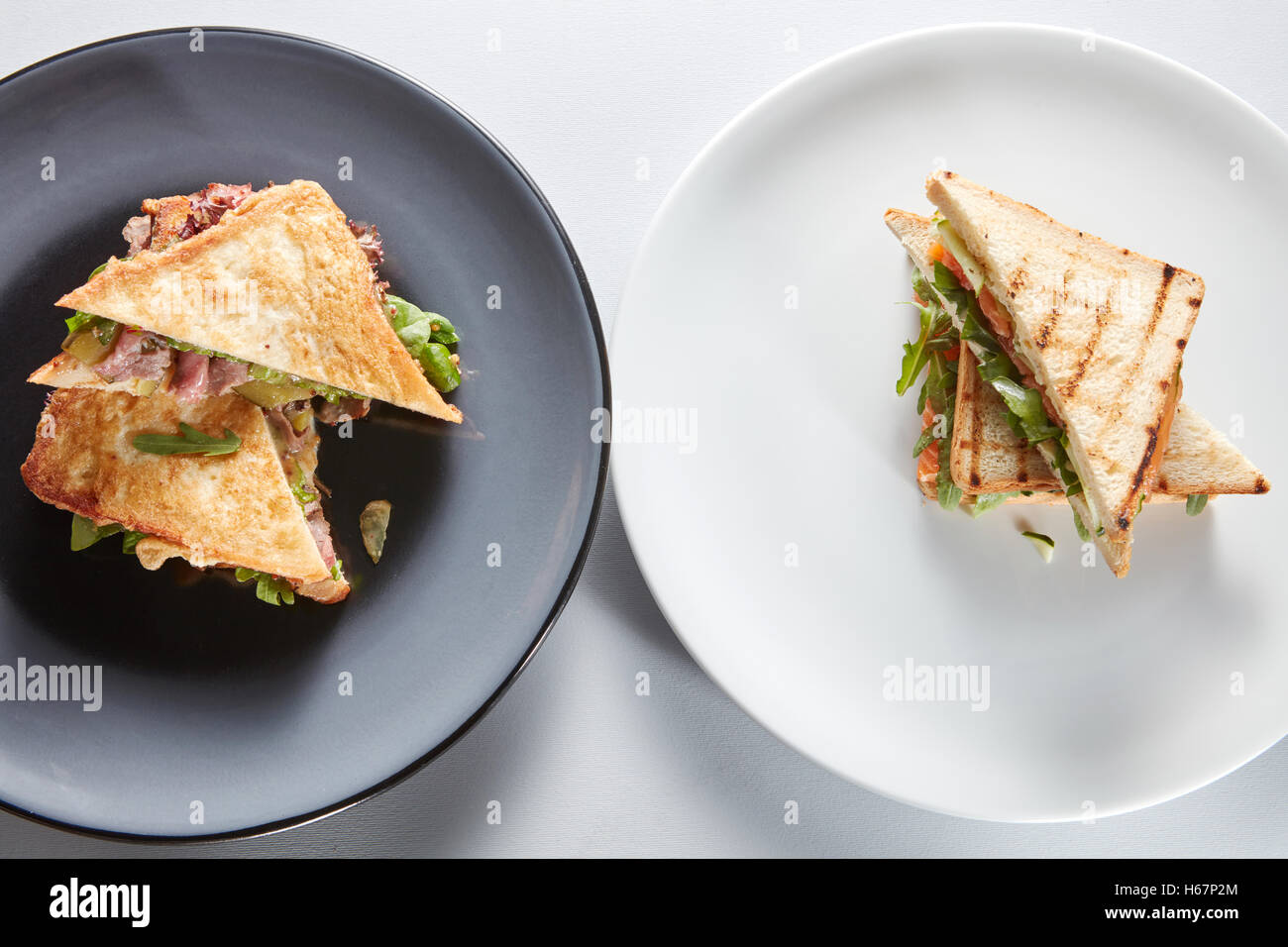 Breakfast with sandwiches on plates and ham with cutlery Stock Photo ...