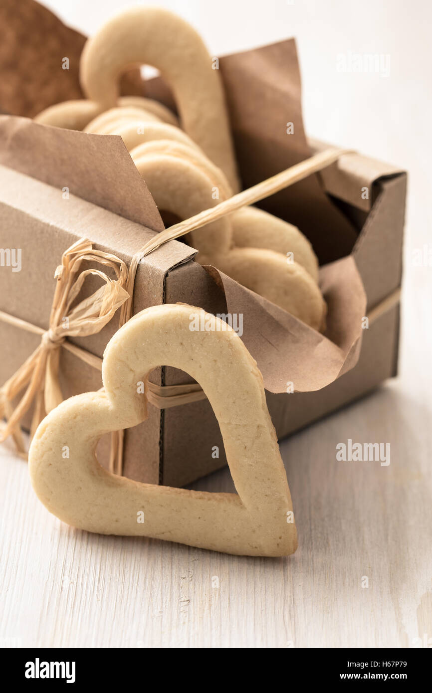 Gift box filled with homemade heart cookies for valentines day on white ...