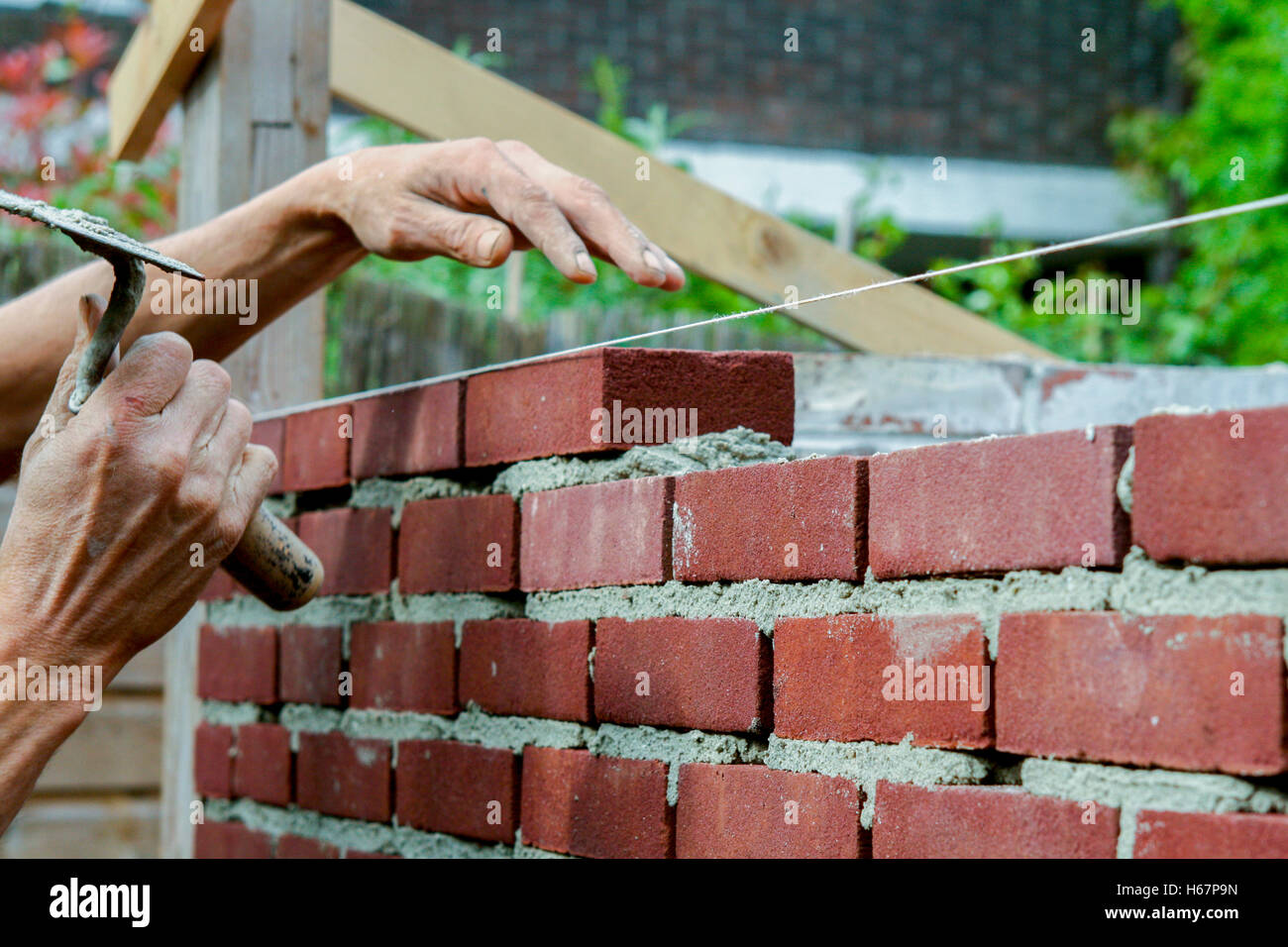Bricklayer with trowel in hand Stock Photo - Alamy