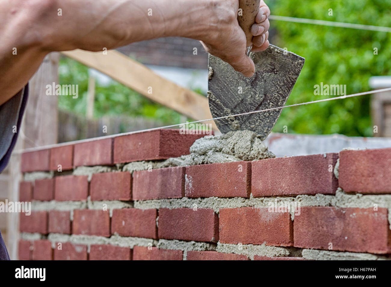Bricklayer working on a wall Stock Photo - Alamy