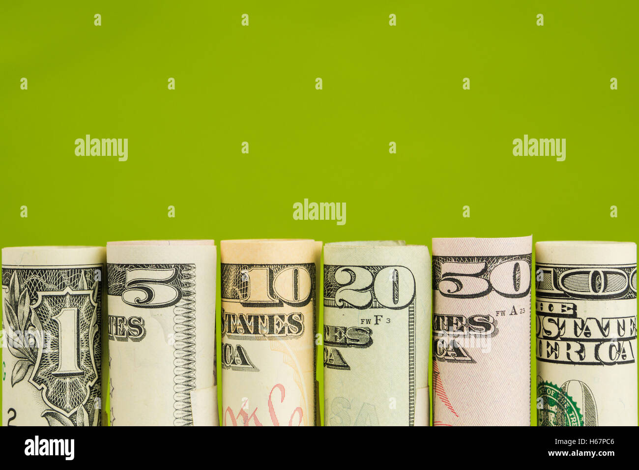 american dollar banknote rolls in all denominations in one row on green ...