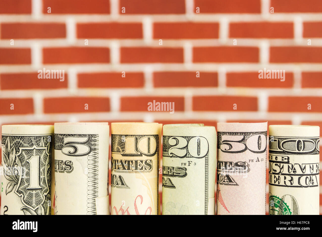 american dollar banknote rolls in all denominations in one row on red ...