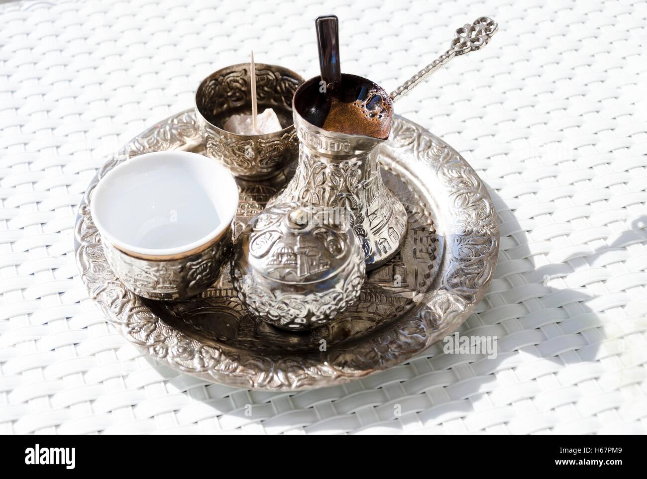 A metallic tray with copper plated cezve (džezva) filled with ...