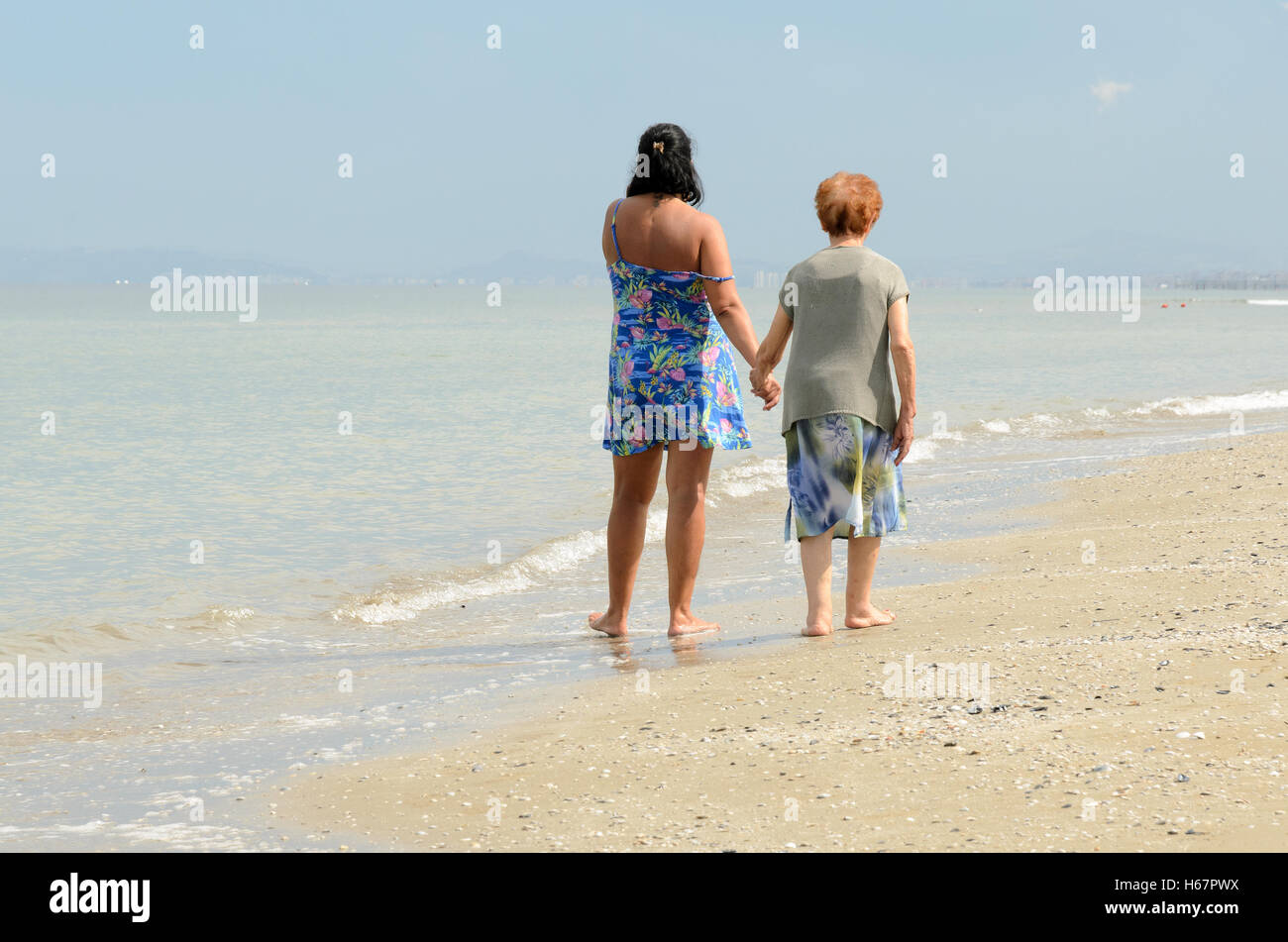 People walking on tropical beach hi-res stock photography and images ...