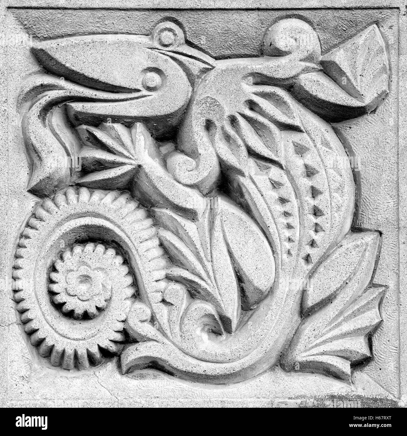 fabulous lizard, a retro stone bas-relief on the wall Stock Photo - Alamy