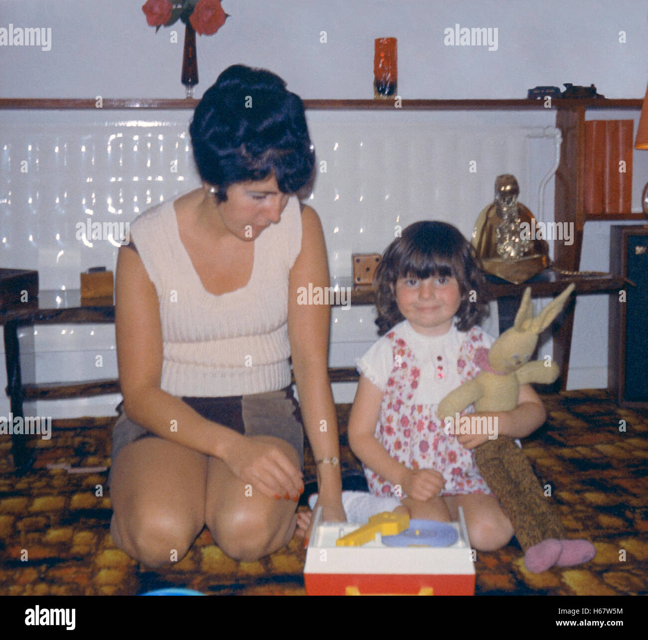 mother and young daughter with toy record player england 1970s Stock ...