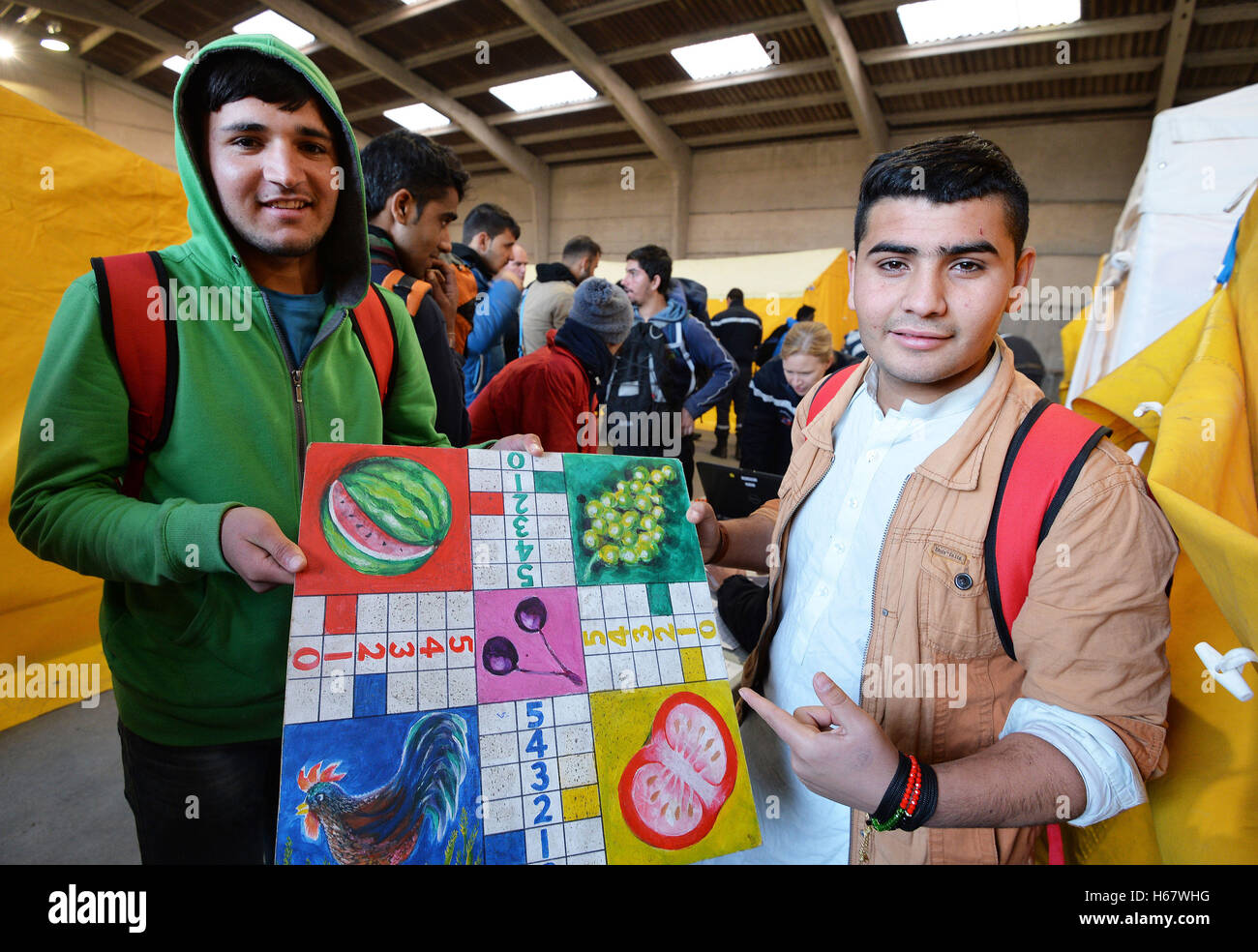 Two Afghan men smile before they leave for their new destination at a ...
