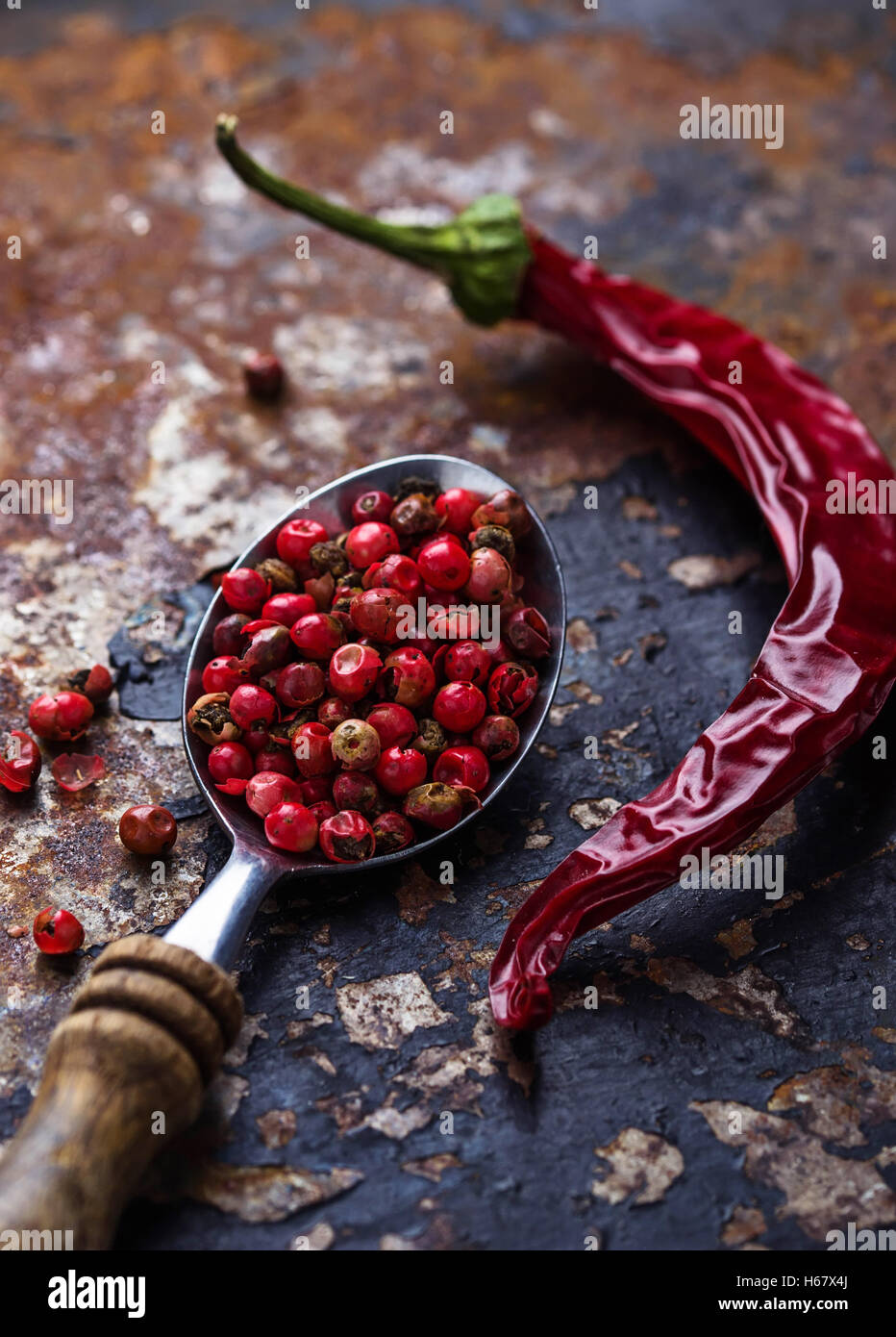 Red chili peppers and rose pepper on slate background. Selective focus ...