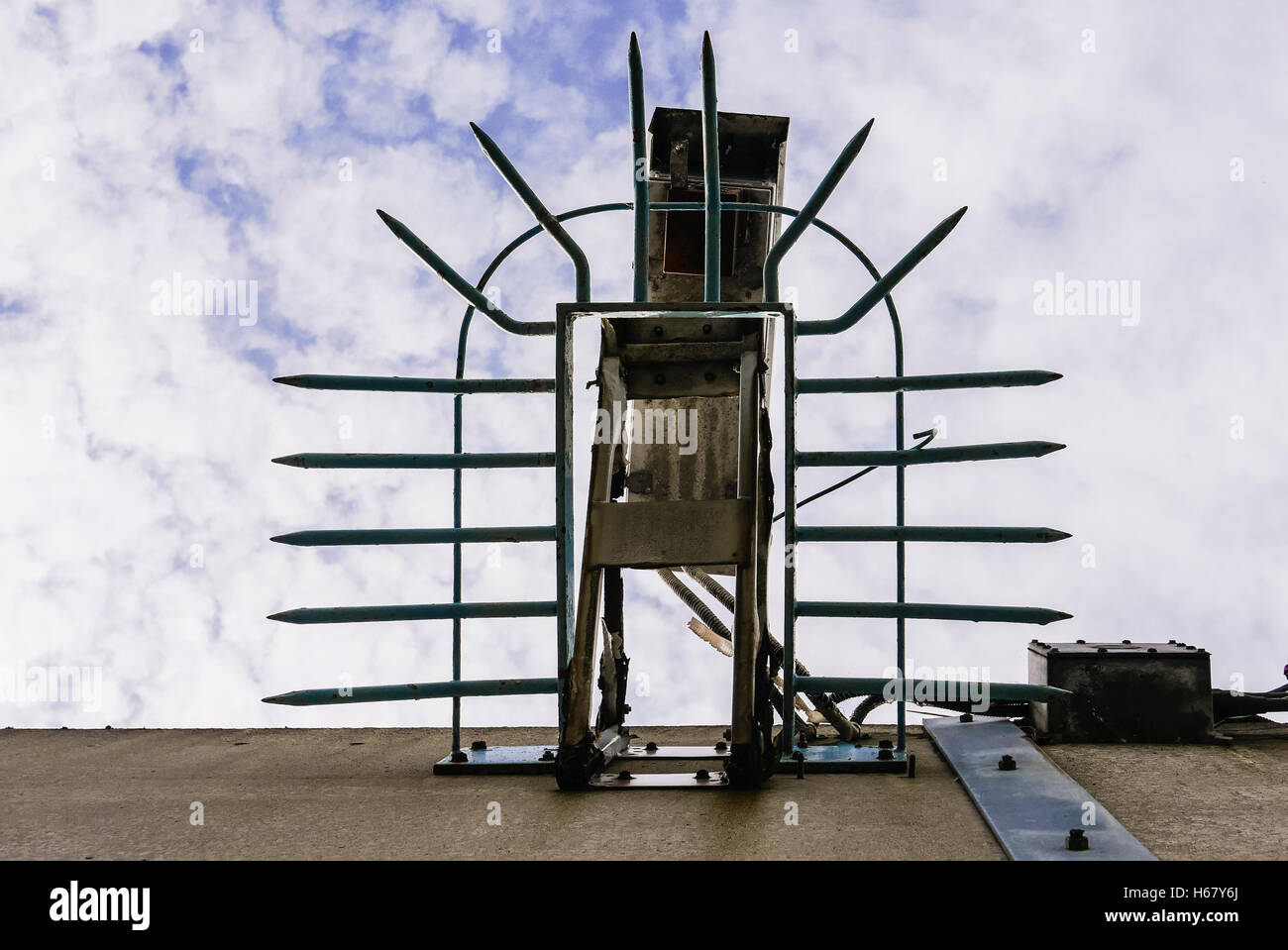 CCTV camera on a wall, with large spikes to prevent climbing and ...