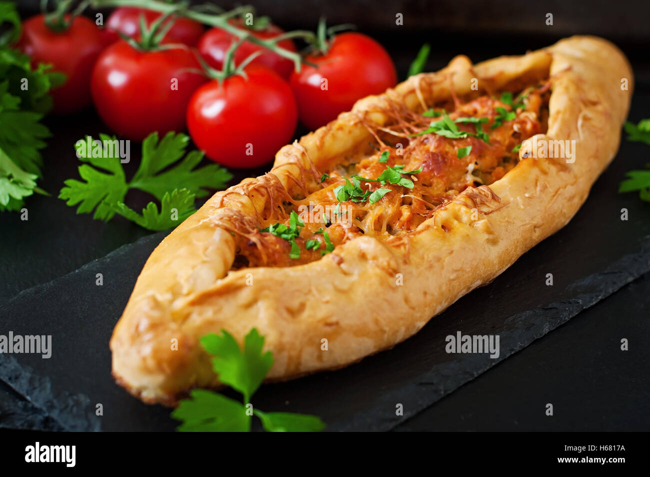 Turkish pide traditional food with beef and vegetables Stock Photo - Alamy