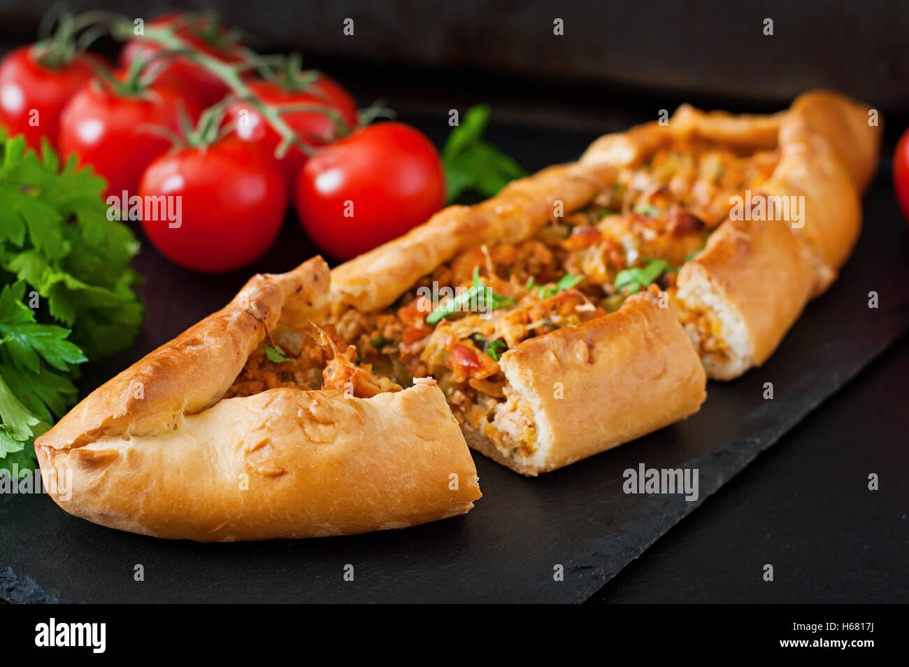 Turkish pide traditional food with beef and vegetables Stock Photo - Alamy