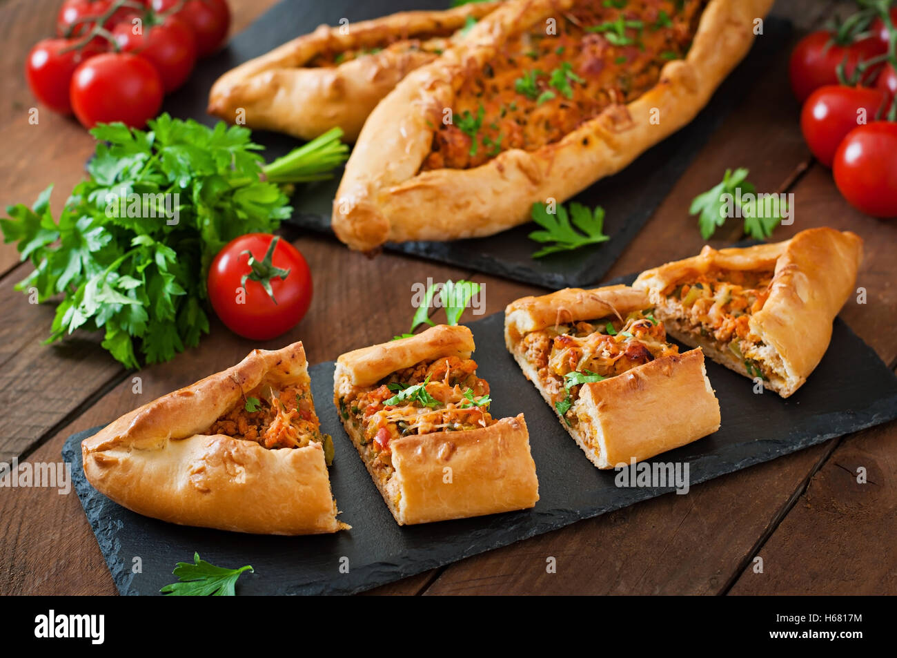Turkish pide traditional food with beef and vegetables Stock Photo - Alamy